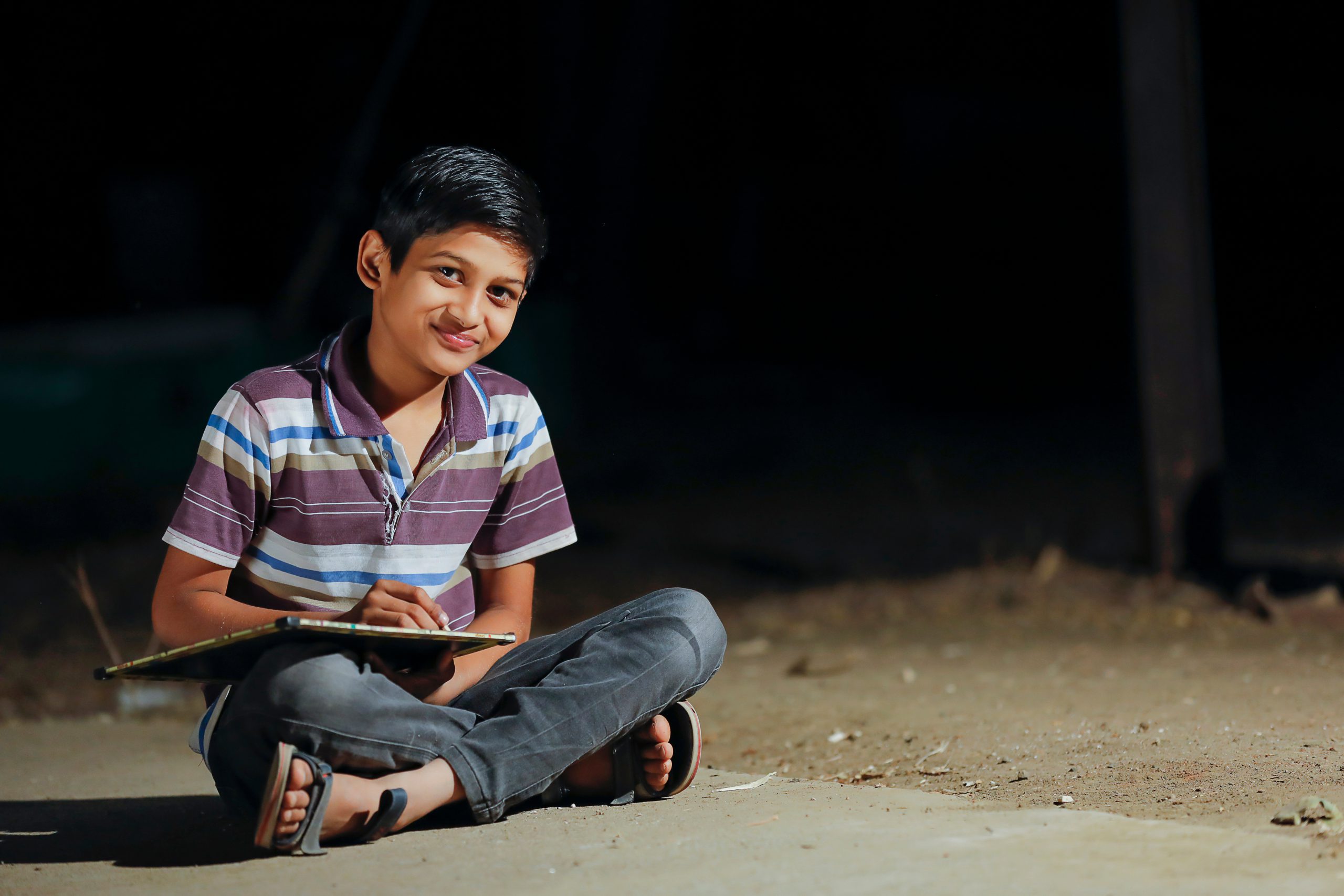 Poor,Child,Doing,His,Homework,At,Home - Humanium