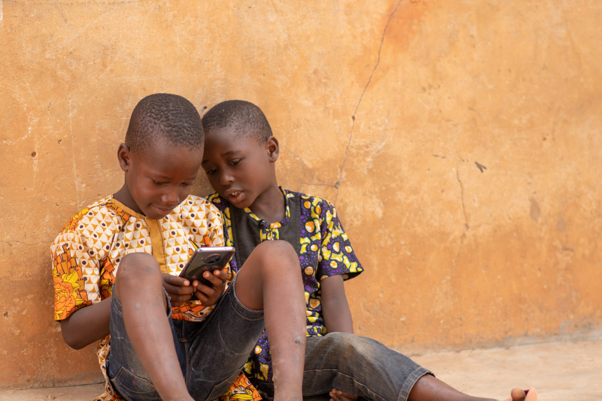 African,Kids,Using,A,Smartphone.,Two,African,Children,Viewing,Content ...