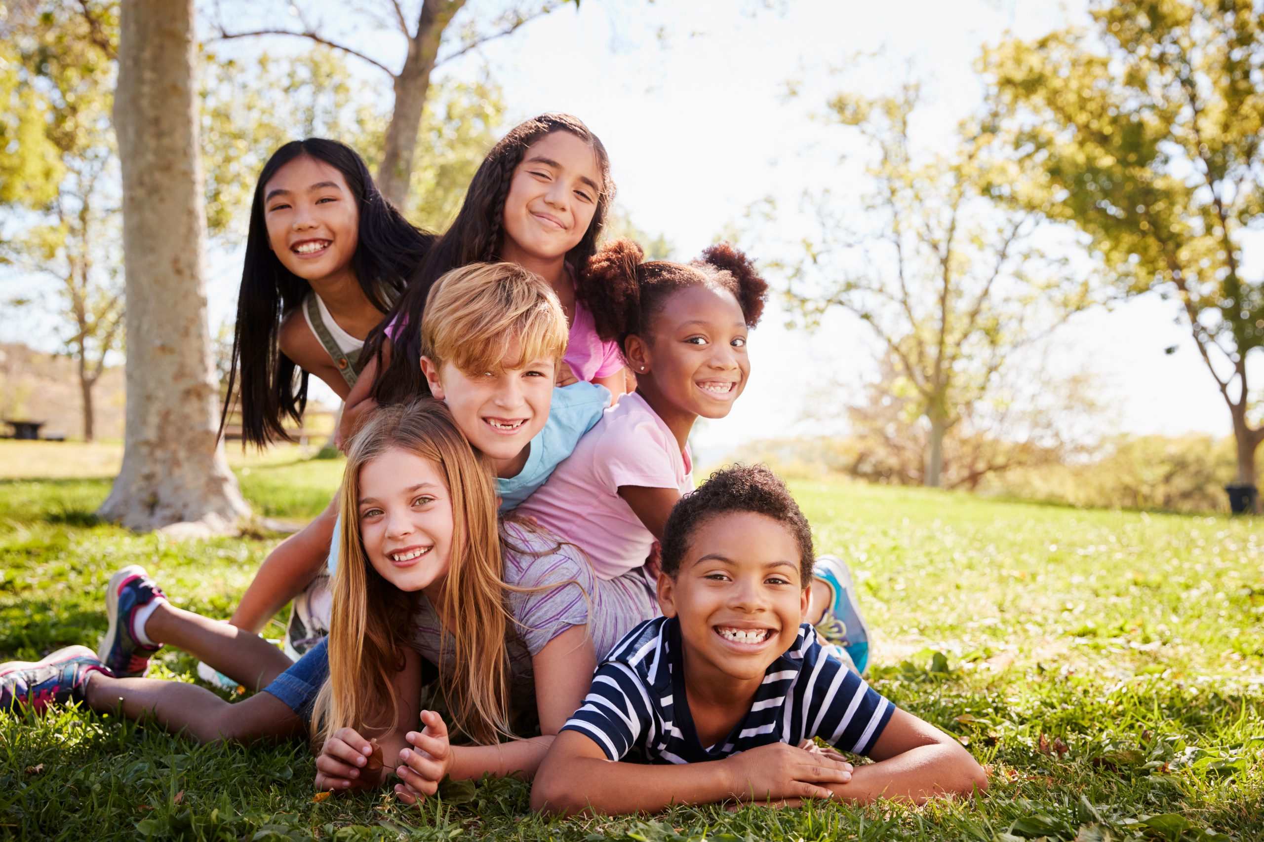 Multi-ethnic,Group,Of,Kids,Lying,On,Each,Other,In,A - Humanium
