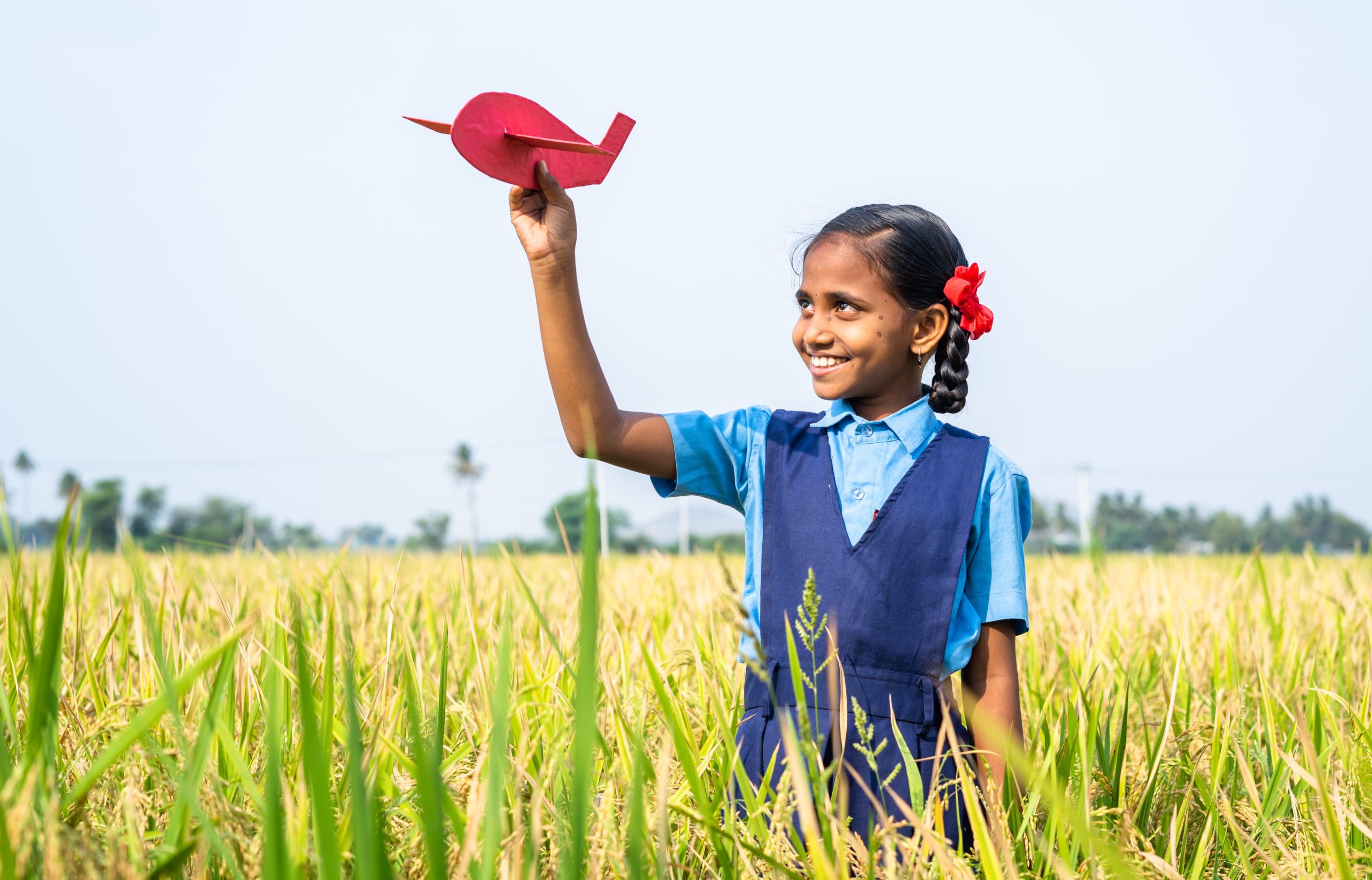 Happy,Village,Girl,Kid,With,School,Uniform,Playing,Using,Toy - Humanium