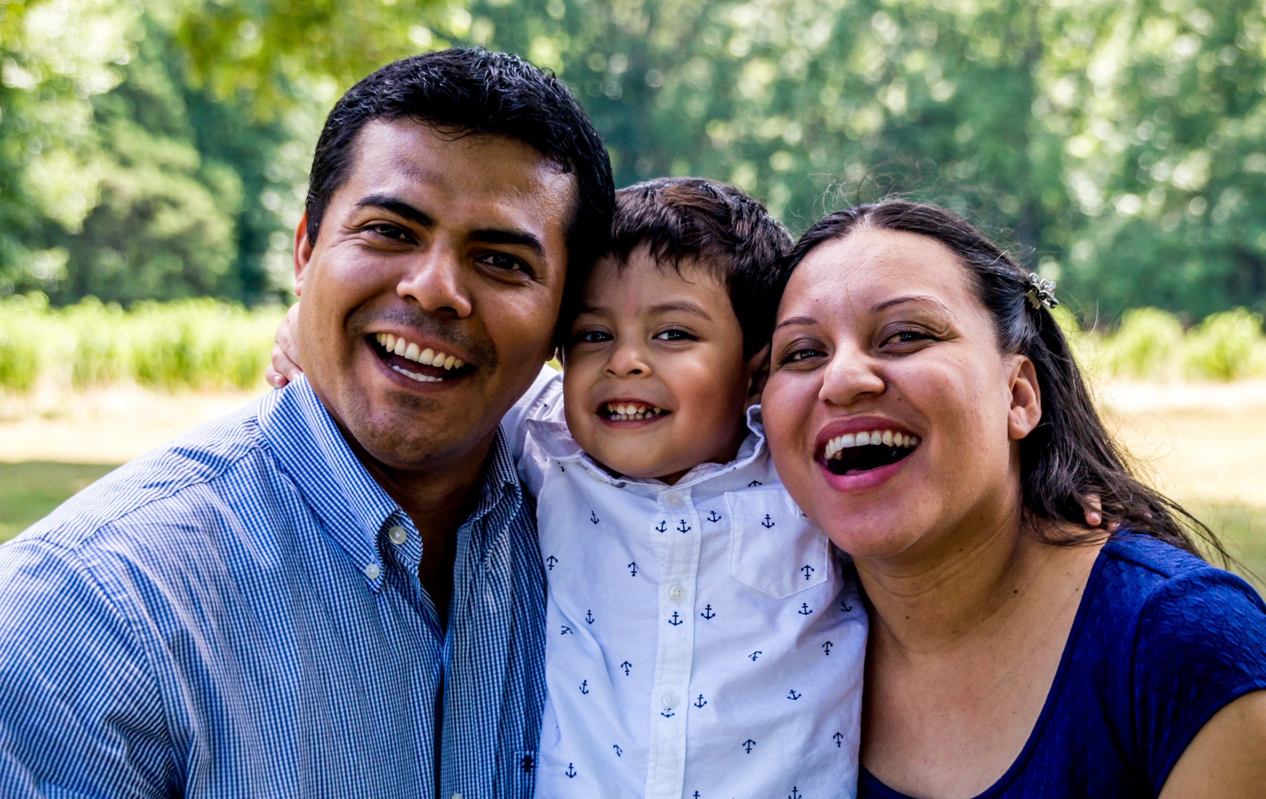Latino,Parents,With,Their,Son,,Smiling,And,Laughing - Humanium