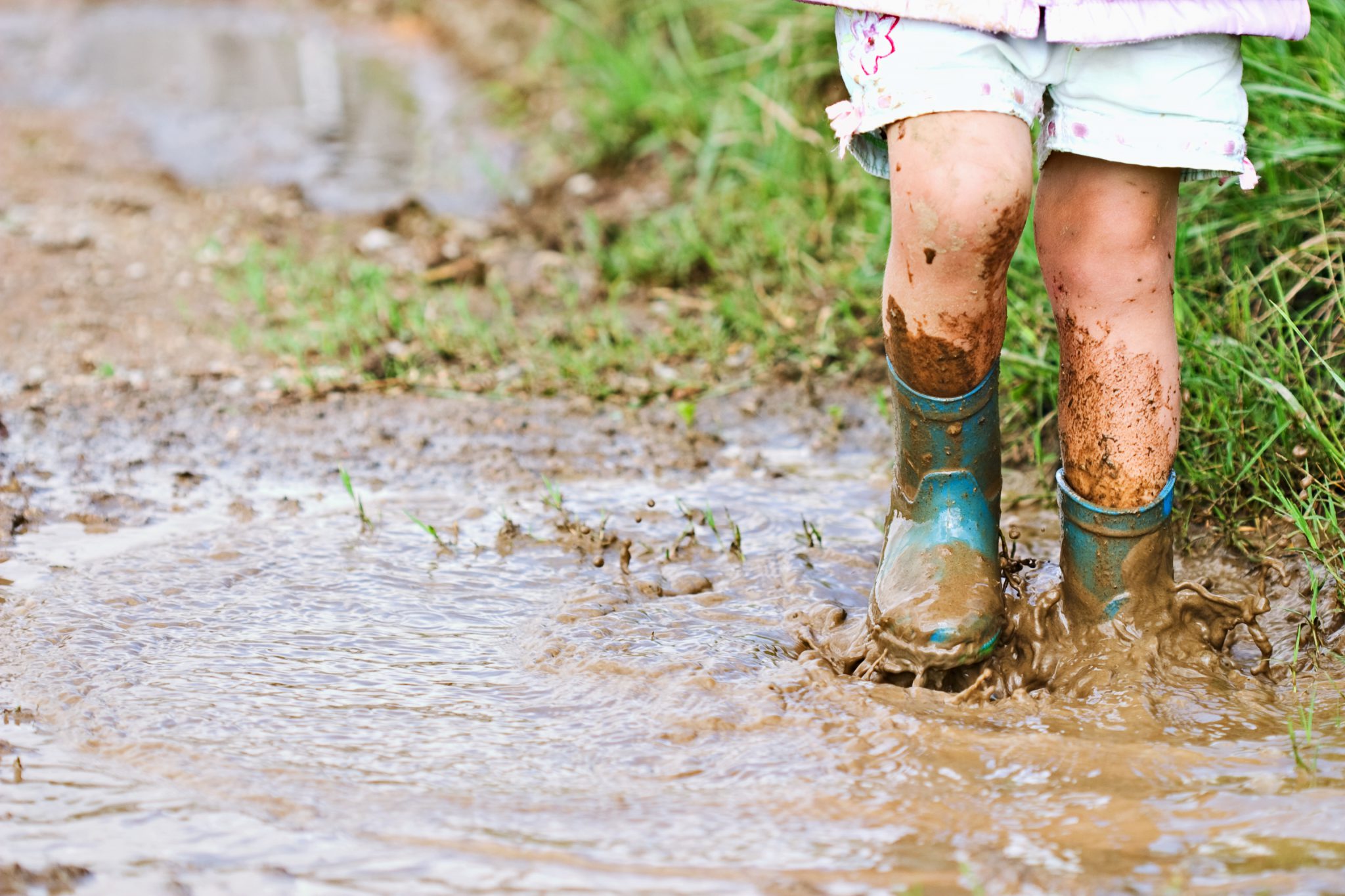 Child's,Feet,Stomping,In,A,Mud,Puddle. - Humanium