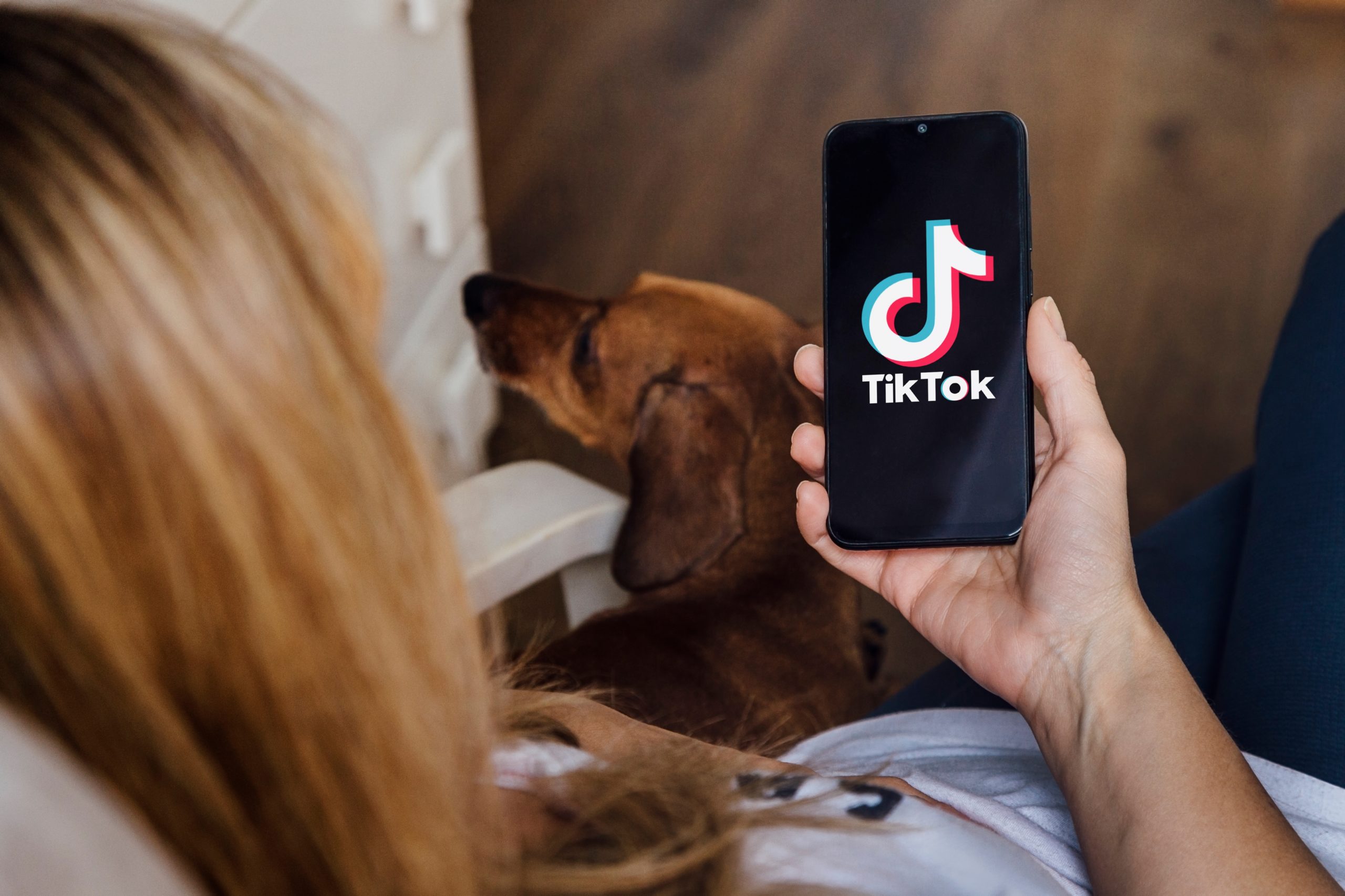 Tiktok,On,Mobile,Phone,Screen.,Woman,Holding,A,Smart,Phone - Humanium